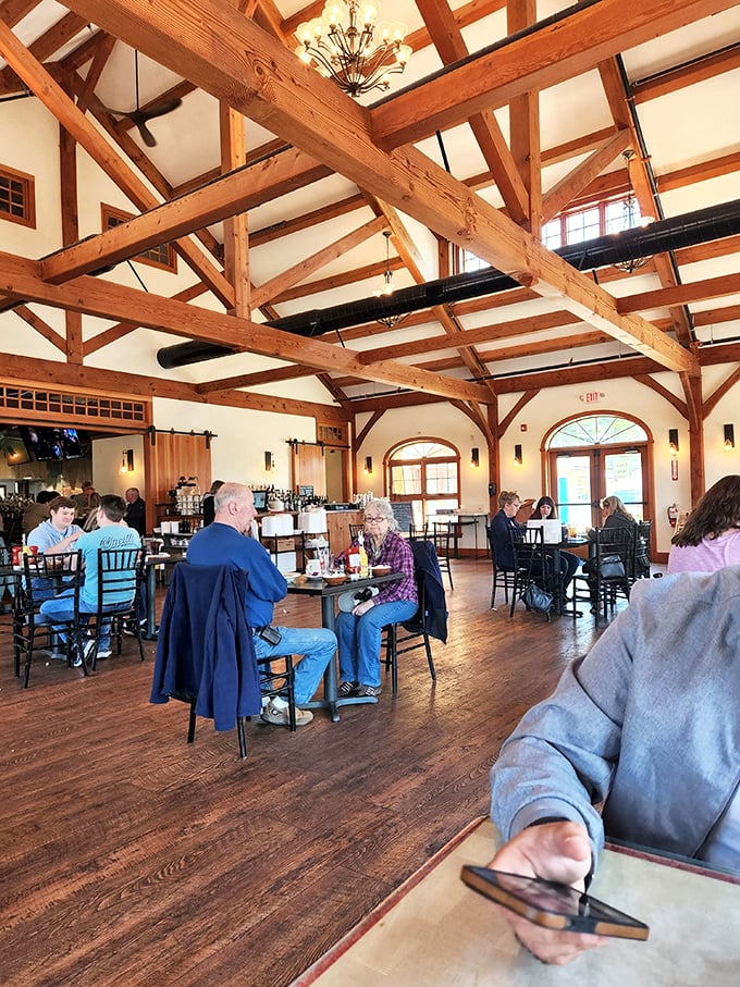 Exposed wooden beams soar overhead while diners below engage in America's favorite pastime: enjoying good food in good company.