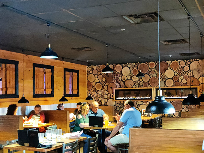 A dining room where wood-paneled walls meet creative log displays&mdash;rustic charm that makes you feel like you've escaped to a mountain lodge.
