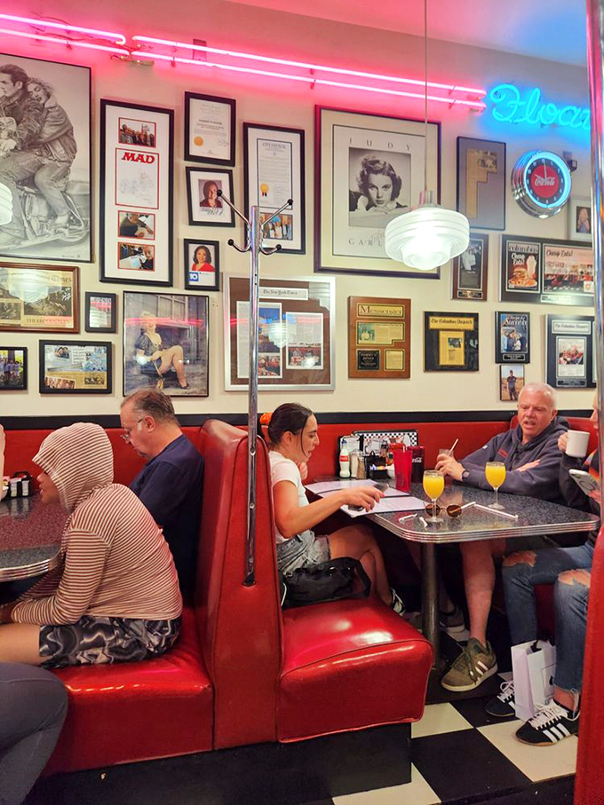 Red vinyl booths cradle conversations between regulars and first-timers alike, while neon lights cast that perfect nostalgic glow over every meal.