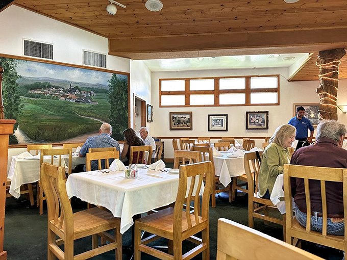 The dining room where strangers become temporary neighbors, united by the universal language of "mmm" and "can I try yours?"