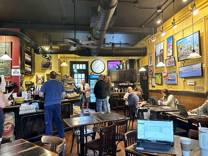 The daily dance of coffee, conversation, and community plays out beneath exposed ductwork and the gentle spin of ceiling fans.