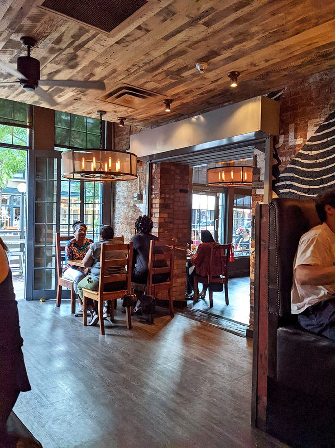 The dining room buzzes with the energy of people having religious experiences with fried chicken. Everyone's too busy eating to check their phones.