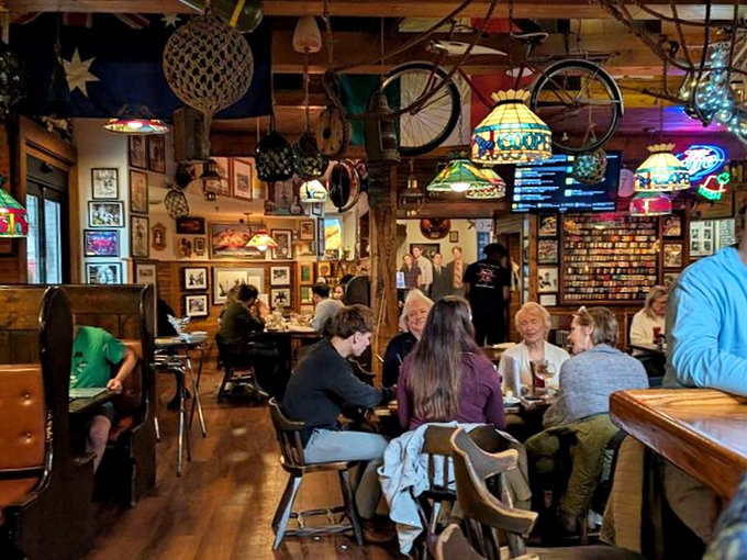 The dining room buzzes with conversation under an eclectic ceiling where bicycles and fishing nets hang like memories from a seafarer's attic.