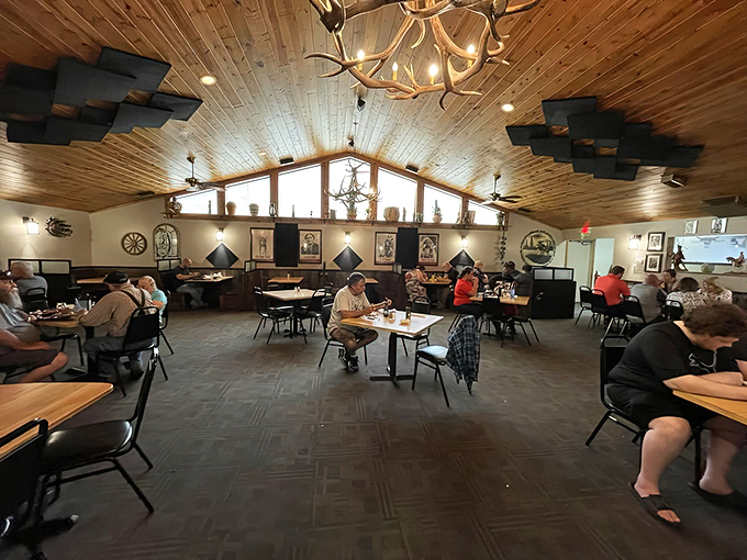 High wooden ceilings and antler chandeliers create a lodge-like atmosphere where comfort food finds its natural habitat.