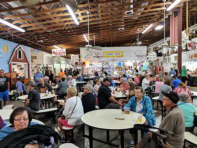 The food court buzzes with the energy of hungry shoppers taking tactical breaks. Notice how the veterans claim tables with the efficiency of seasoned flea market commandos.
