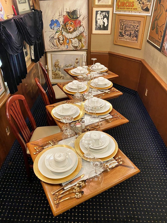 Fine dining meets railroad romance in this elegantly set table area, where white linens and golden chargers await passengers of the culinary kind.