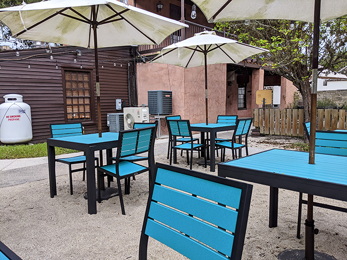 Turquoise chairs pop against sandy ground—a Florida color palette as refreshing as the food served in this historic courtyard.