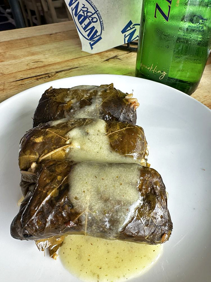 Dolmades wrapped with the care of a grandmother's hug. These grape leaves conceal a rice filling that's worth the unwrapping.