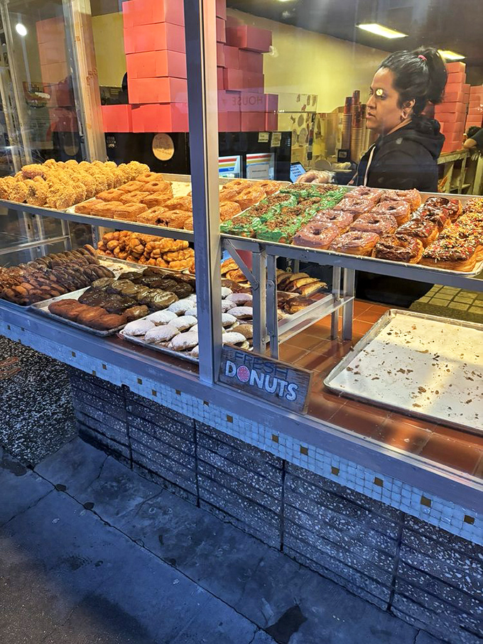 The display case: a museum of edible art where decisions become impossible and "I'll take one of each" becomes reasonable.