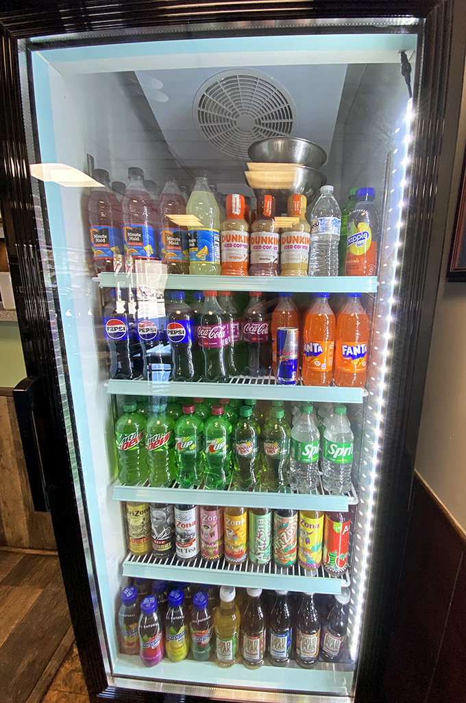 The beverage cooler stands like a colorful oasis of fizzy possibilities, proving that sometimes happiness comes in plastic bottles.