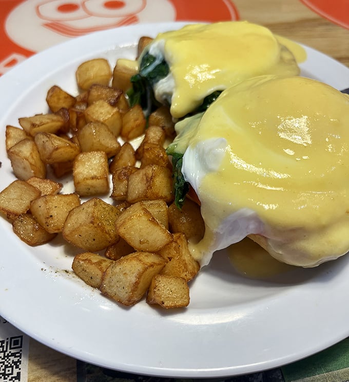 Eggs Benedict that balances decadence with technical precision. That hollandaise sauce is sunshine yellow for a reason&mdash;it's bringing brightness to your morning.