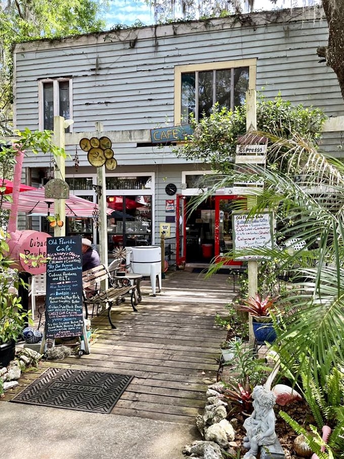 The approach to paradise—a wooden walkway flanked by lush Florida greenery leading to that iconic red door.