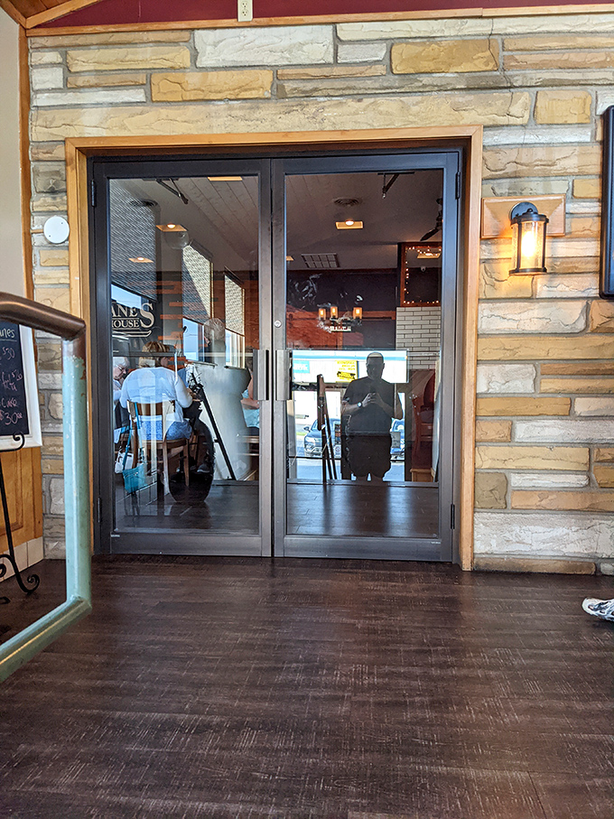 The entrance beckons with warm lighting and stone details&mdash;like a portal to a world where calories don't count and decisions only involve what to order.