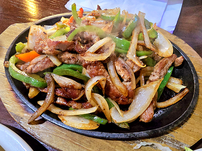 Sizzling fajitas announce their arrival before you see them. This hot skillet of perfectly seasoned meat and vegetables performs the most aromatic tableside show in town.