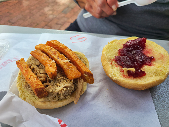 Turkey sandwich innovation: shredded turkey topped with what appears to be cranberry sauce and crispy elements. Thanksgiving dinner in handheld form!