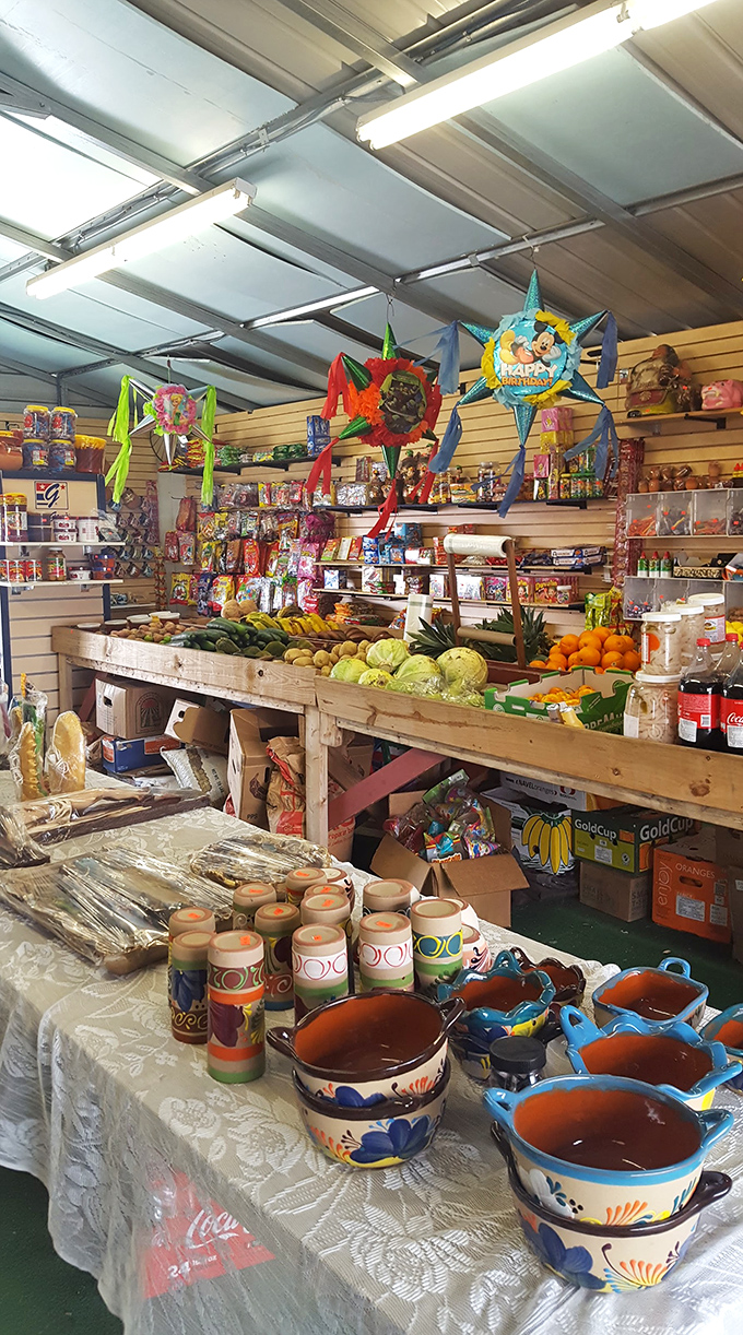 Produce meets pi&ntilde;atas in this sensory wonderland. Fresh fruits and vegetables share space with colorful pottery, proving that practical and whimsical can coexist beautifully.