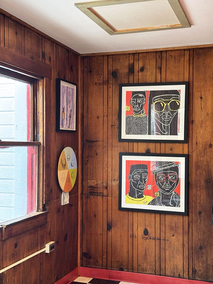 Art that watches you eat. These distinctive prints add character to the wood-paneled walls, silent witnesses to countless burger epiphanies.