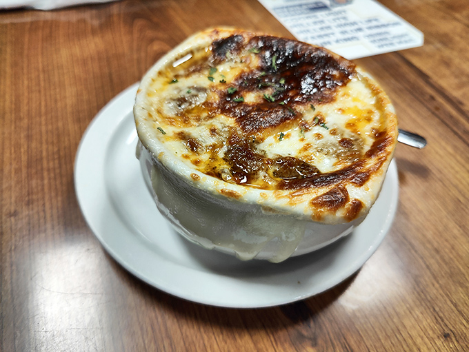 French onion soup with a cheese cap so perfectly browned, it deserves its own standing ovation. Spoon-breaking satisfaction guaranteed.