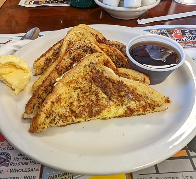 French toast that's achieved that mythical balance &ndash; crispy edges, custardy centers, and just waiting for its maple syrup swimming lesson.