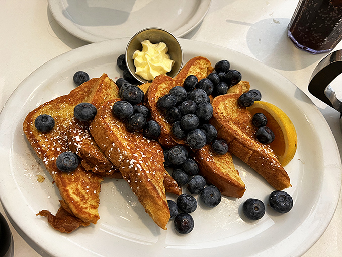 French toast that doesn't just ask for your attention but demands it, wearing blueberries like sapphires on a golden crown.