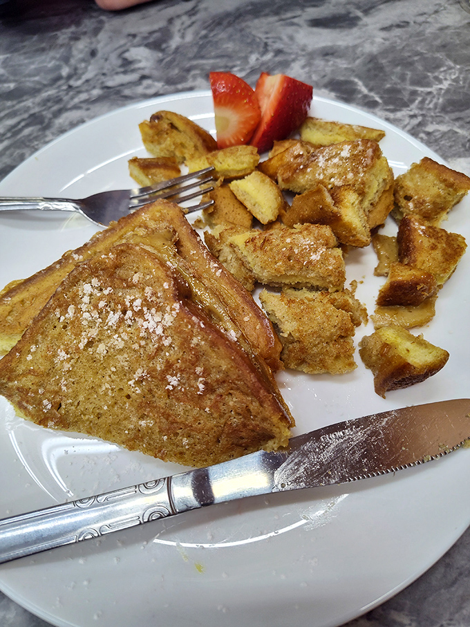 French toast that makes you question why anyone would eat cereal, served with cinnamon-kissed cubes of joy and fresh strawberries.