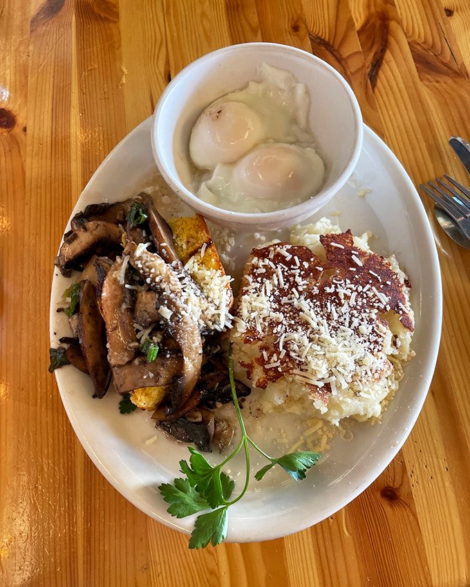 A plate that tells a story of culinary creativity&mdash;poached eggs, saut&eacute;ed mushrooms, and what appears to be cheesy polenta creating a breakfast symphony.