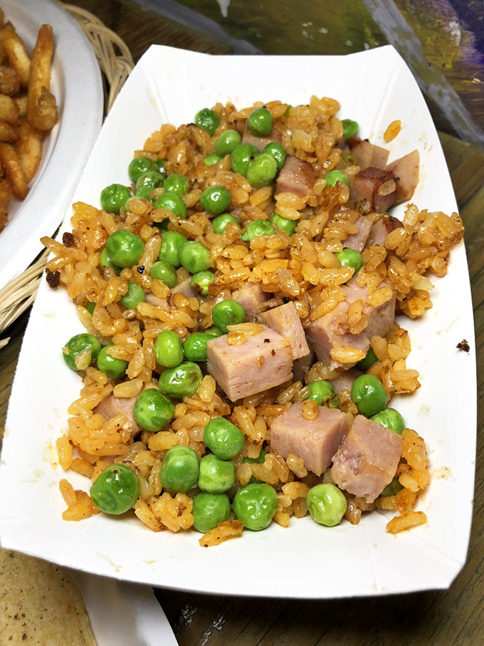 Fried rice that defies cultural boundaries. Those peas and ham cubes are living their best life in a sea of perfectly seasoned grains.