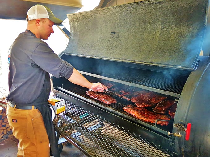 A pitmaster tending to ribs with the focus of a surgeon and the intuition of an artist. This is where the magic happens.