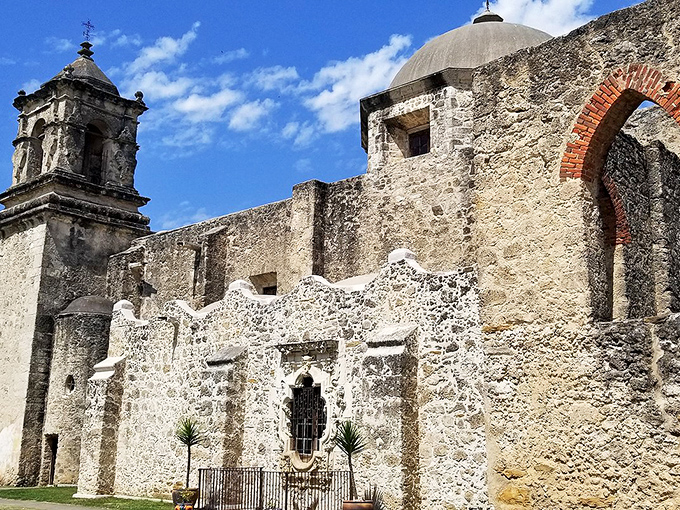 The mission's iconic bell tower rises majestically, calling visitors to experience centuries of spiritual and cultural heritage.