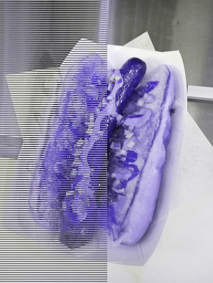 Even in this artistic blue filter, you can tell this hot dog means business&mdash;loaded with toppings and ready for its close-up.