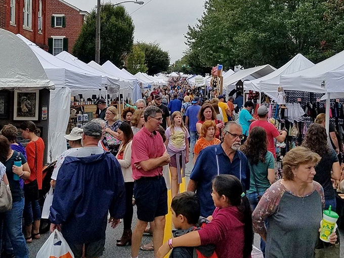 The Hummelstown Arts Festival transforms streets into galleries, where white tents house treasures and the crowd itself becomes a colorful, moving exhibition.