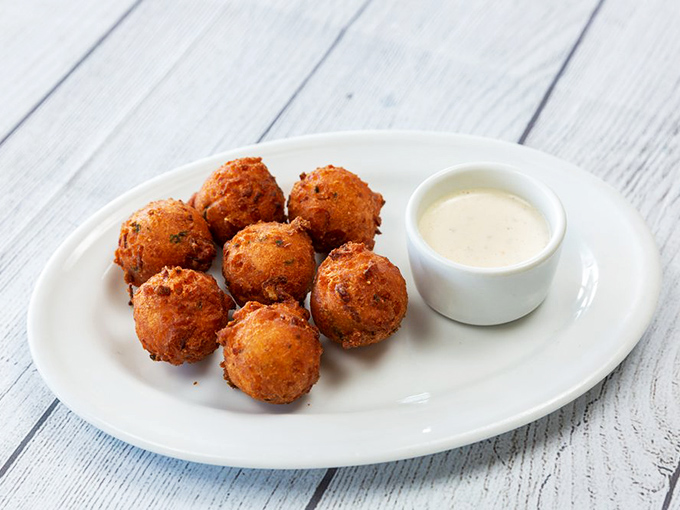 These hush puppies aren't staying quiet about how delicious they are&mdash;golden-fried cornmeal fritters with a pillowy interior that demands attention.