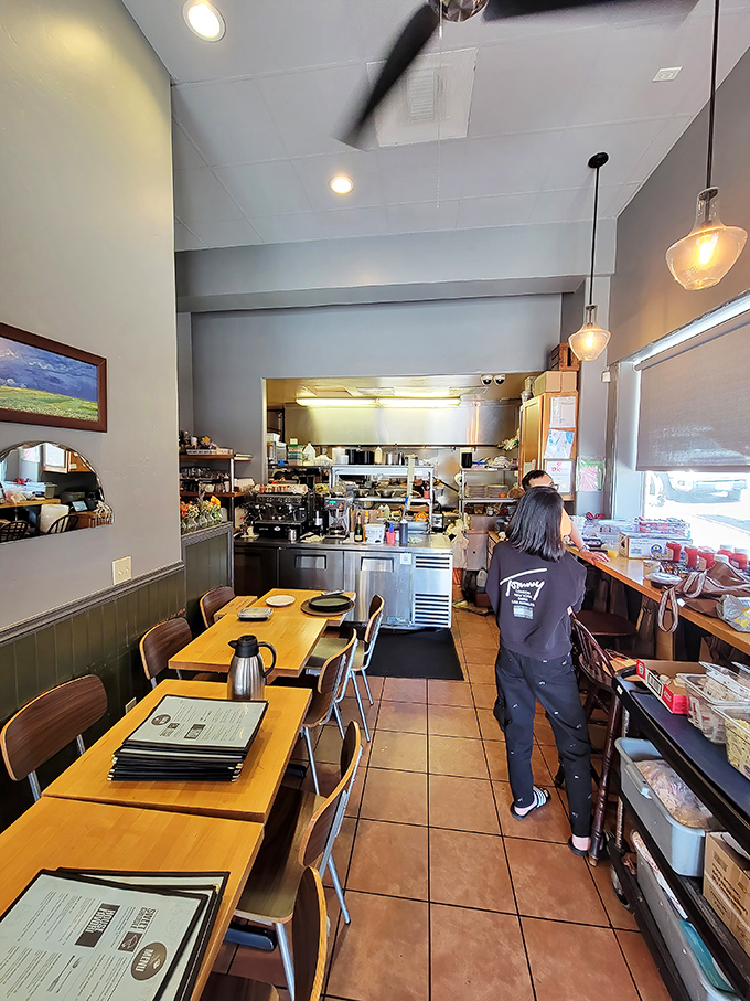 The narrow, cozy interior creates an intimate breakfast experience where conversations bloom alongside steaming coffee cups.