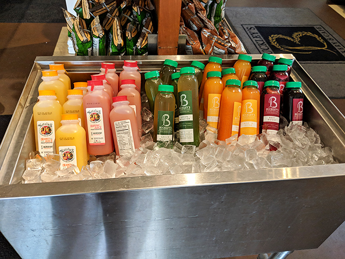 Buckley's bottled juices lined up like colorful soldiers ready to battle your thirst. That vibrant array is basically a liquid rainbow of refreshment.