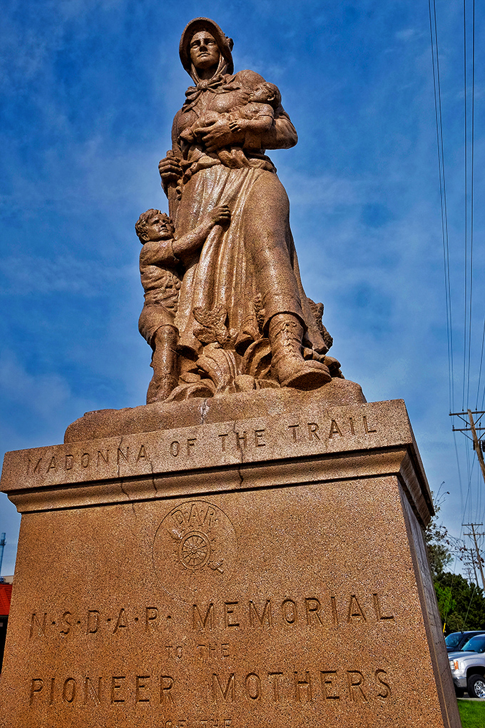 The Madonna of the Trail stands proudly, honoring the pioneer women who helped settle the West. She's been giving directions since before GPS was a twinkle in technology's eye.