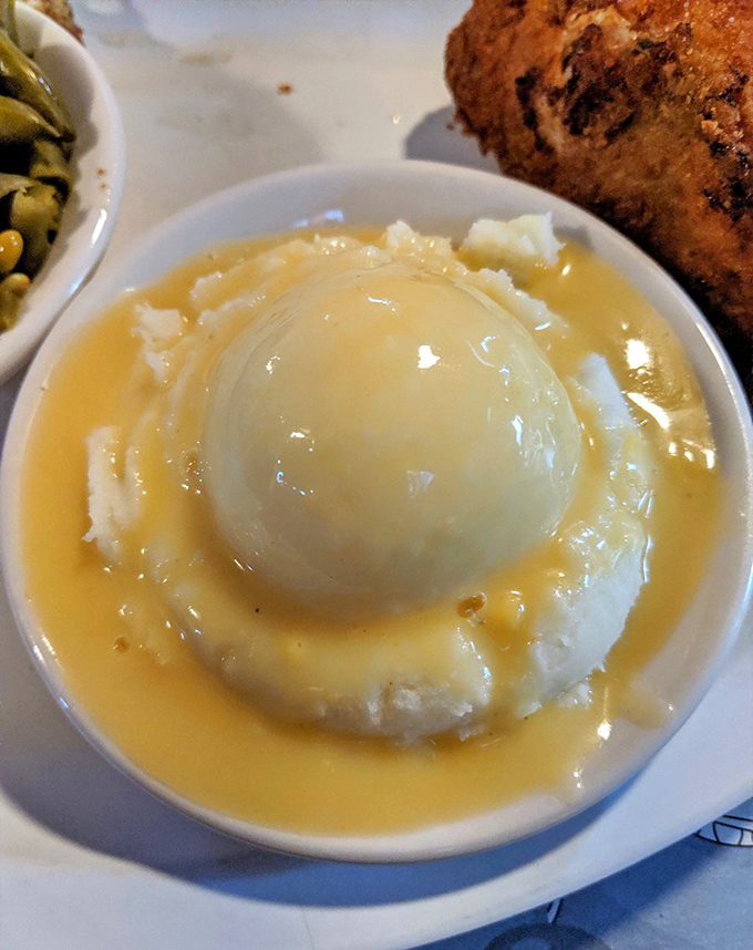 Mashed potatoes with gravy and a perfectly centered hard-boiled egg—comfort food architecture at its finest.