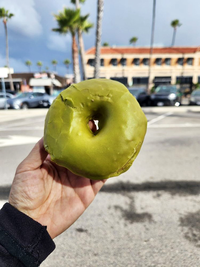 The matcha donut against Newport Beach's palm trees creates a perfect California moment&mdash;where wellness culture and indulgence somehow peacefully coexist.