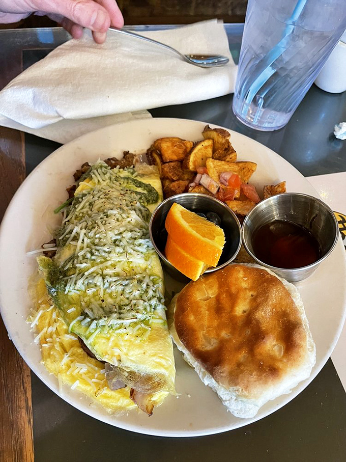 This omelet doesn't just sit on the plate&mdash;it commands attention with melted cheese, fresh sides, and a biscuit that's begging to be buttered.