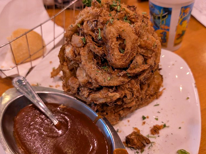 The Onion Brick&mdash;architecture meets appetite in a towering achievement of crispy, golden rings. Dipping sauce stands ready for its supporting role in this crunchy drama.