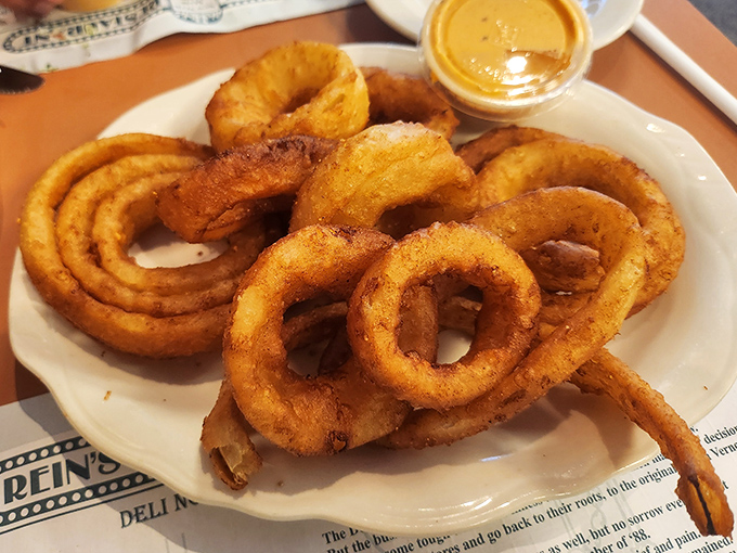 Onion rings with the perfect crunch-to-softness ratio, stacked high like delicious golden halos. Diet plans enter at their own risk.