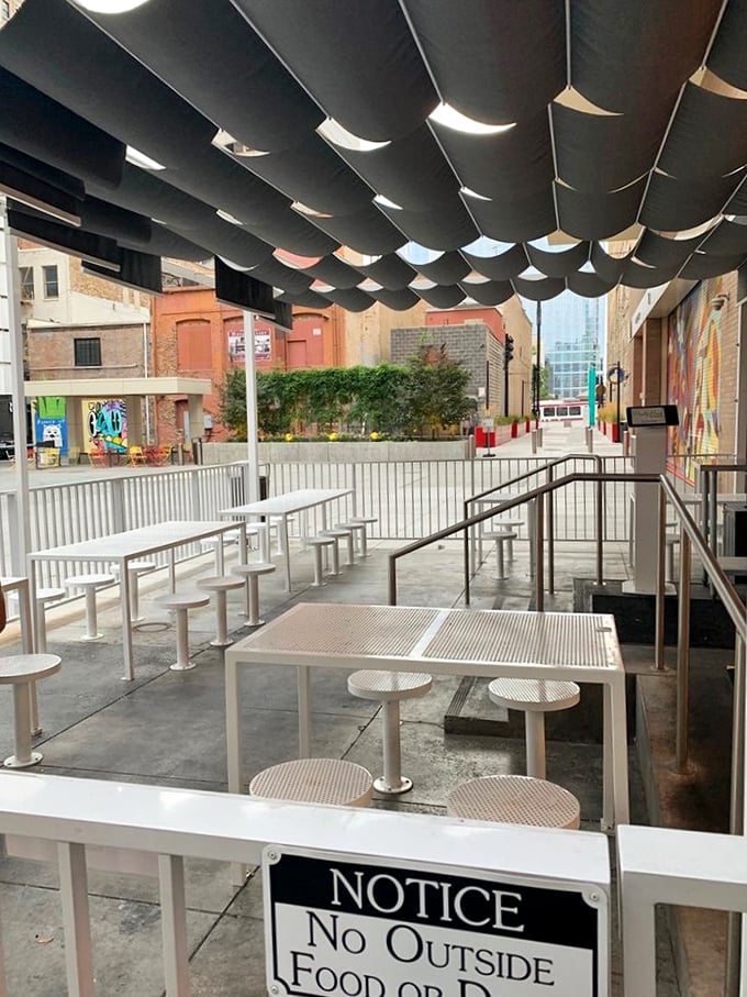 The patio's minimalist design lets the food take center stage, while those fabric panels provide just enough shade.