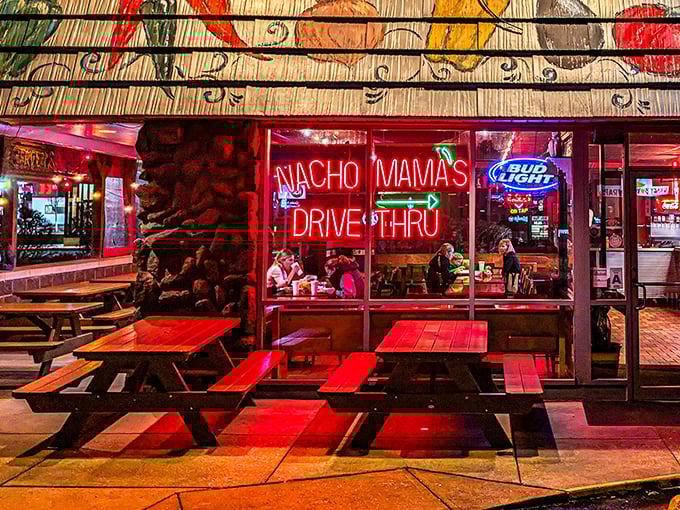 As night falls, the neon "DRIVE THRU" sign transforms Nachomama's exterior into a beacon for hungry night owls seeking Tex-Mex salvation.