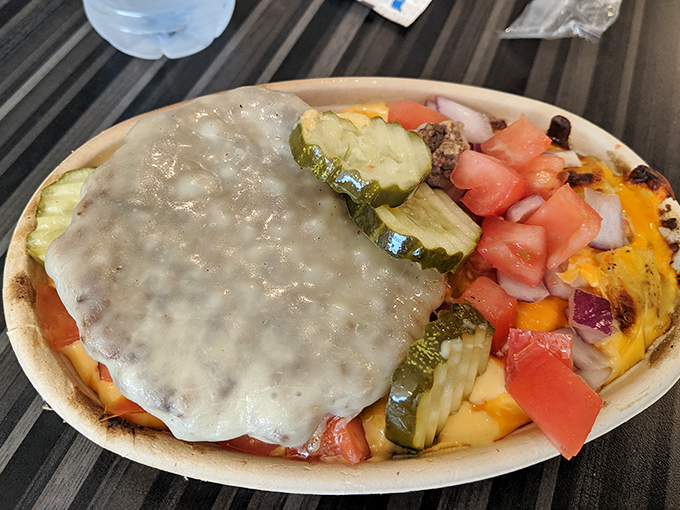 This mac and cheese creation comes with its own geography &ndash; mountains of toppings, valleys of sauce, and a pickle peninsula on the side.