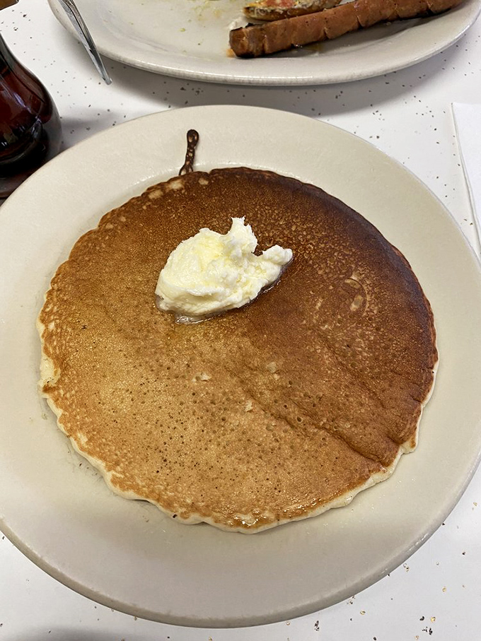 Pancake artistry in its purest form. That perfect golden-brown canvas awaits only your choice of syrup trajectory &ndash; straight down the middle or spiral approach?
