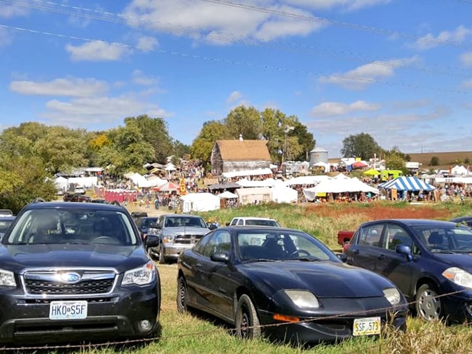 The packed parking field reveals Junkstock's popularity, where cars line up like eager shoppers waiting for their turn at treasure hunting.