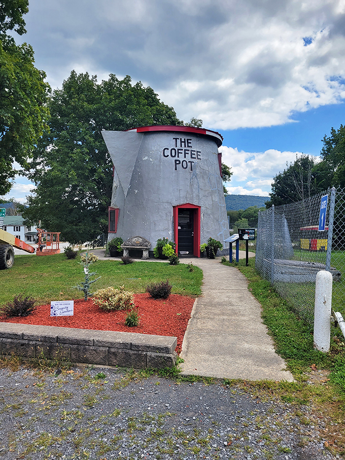 The pathway to The Coffee Pot is lined with carefully tended plants&mdash;a red carpet welcome to America's most caffeinated architectural oddity.