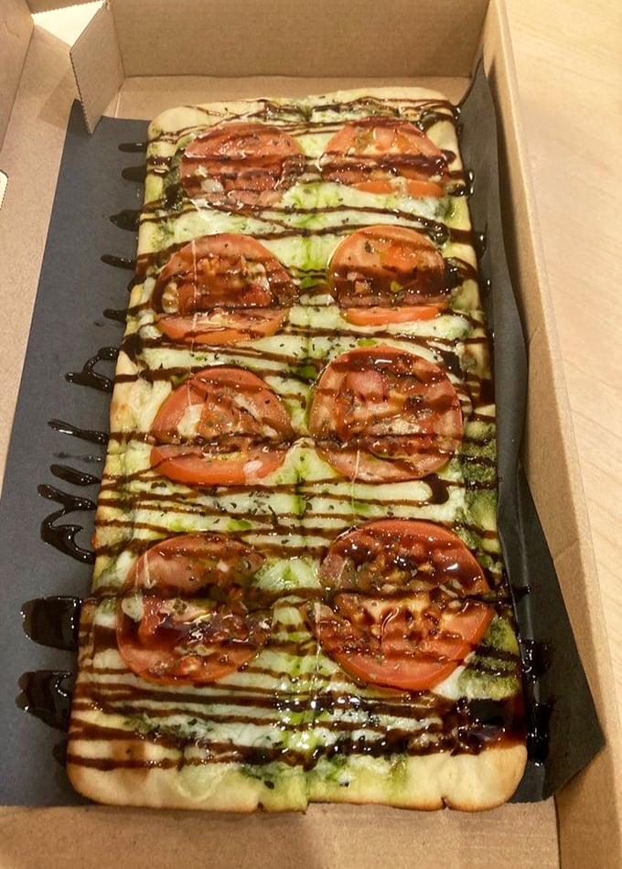 This flatbread pizza proves they're not just a one-trick pony. The balsamic drizzle creates edible art that's almost too pretty to eat. Almost.