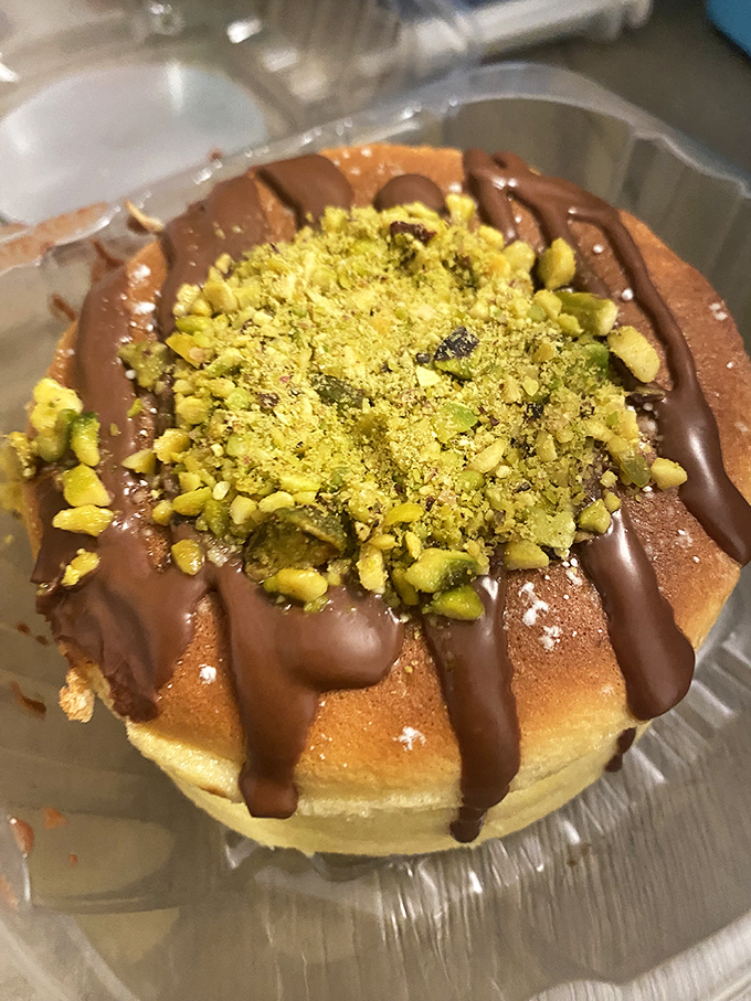 Chocolate drizzle and pistachio crumble create a sweet-savory symphony atop this cheesecake&mdash;proof that sometimes the best accessories are edible.