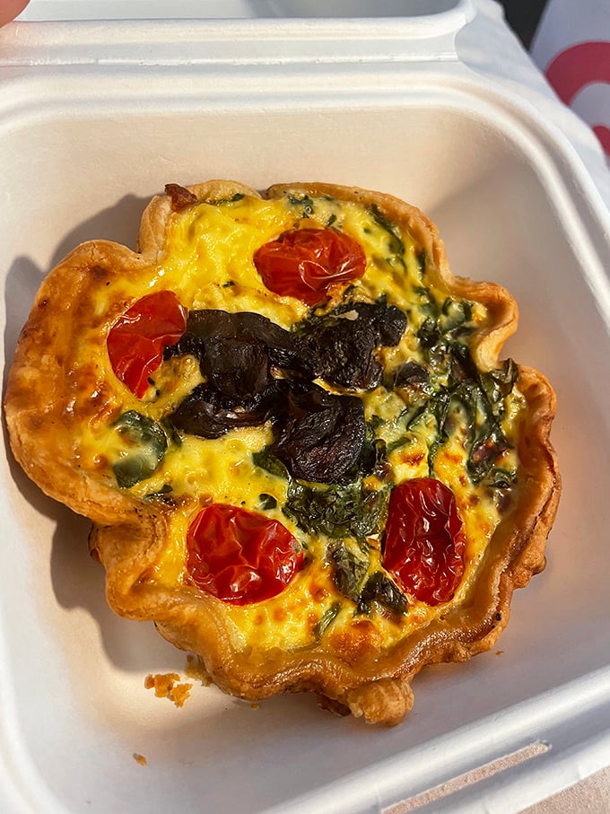 This quiche isn't just breakfast&mdash;it's a savory masterpiece with roasted tomatoes and greens standing at attention in a sea of perfect custard.