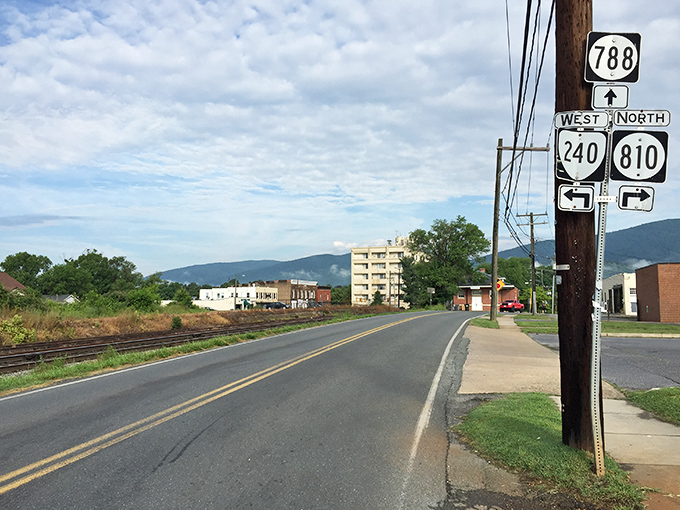 Highway signs point to adventures in every direction, while the Blue Ridge Mountains stand sentinel in the background&mdash;nature's own GPS for the soul.